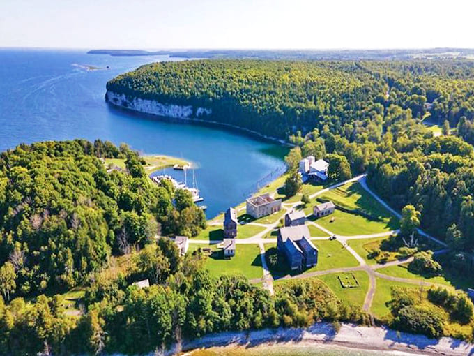 Aerial majesty: Fayette Historic State Park's stunning peninsula juts into Lake Michigan like nature's perfect postcard, history nestled between forest and water.