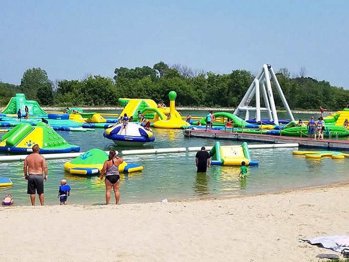 A colorful aquatic playground comes to life with vibrant inflatables dotting the clear Wisconsin waters.