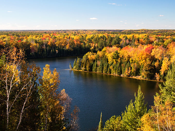 Nature's masterpiece unfolds at Foote Pond Overlook, where autumn paints the landscape in fiery hues that would make even Monet jealous.