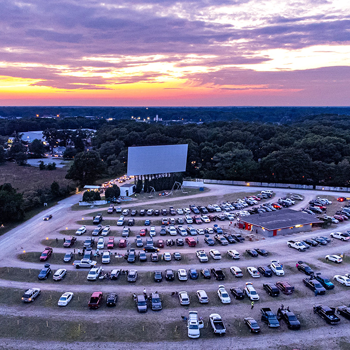 The Getty Drive-In's iconic sign stands tall against Michigan's evening sky, a beacon calling movie lovers to gather under the stars.