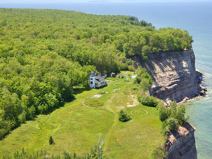 Perched dramatically on the edge of forever, this aerial view of Grand Island showcases nature's perfect balance of forest and cliff.