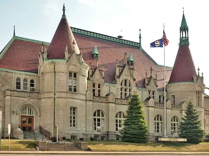 The majestic Hoyt Public Library stands like a literary castle in Saginaw, its red-tiled turrets and stone facade promising adventures within its walls.