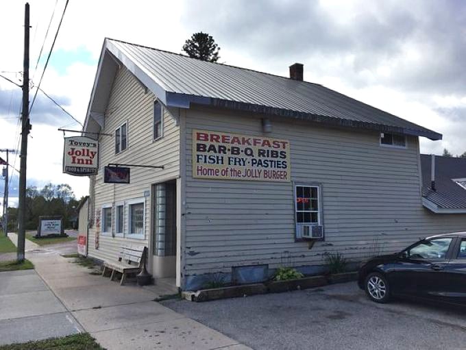 Tovey's Jolly Inn stands proudly in Germfask, its unassuming exterior hiding culinary treasures that have made it a legendary Upper Peninsula destination.