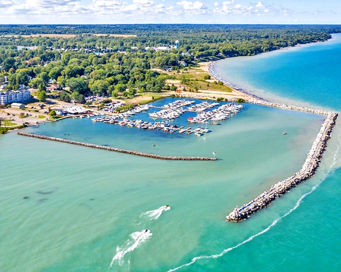 Lexington's harbor embraces the turquoise waters of Lake Huron like a protective hug, with boats nestled in their slips like colorful jewels in a perfectly designed setting.