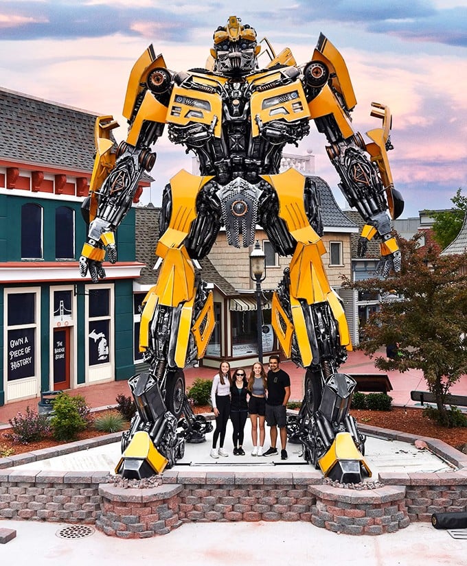 Mack-A-Tron stands sentinel over Mackinaw Crossings, a 30-foot yellow guardian made from automotive parts and bridge pieces that stops shoppers in their tracks.