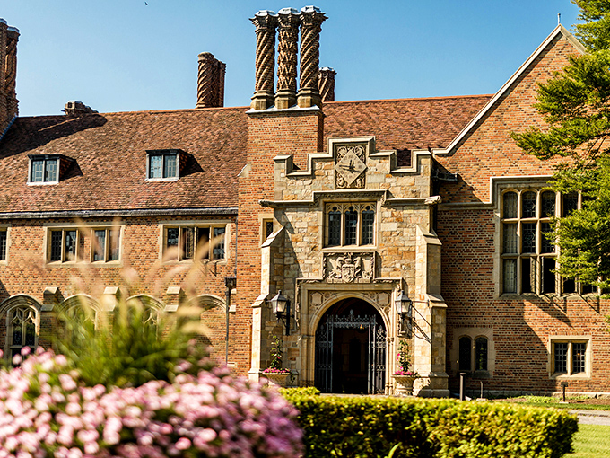 Meadow Brook Hall's imposing Tudor facade stands proudly against the Michigan sky, its twisted chimneys reaching skyward like architectural exclamation points.