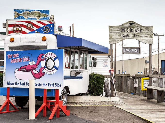 A nautical paradise awaits at Mike's on the Water, where a converted food truck and weathered dock sign promise seafood treasures ahead.