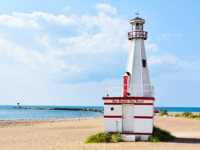 The iconic white and red lighthouse stands sentinel at New Buffalo Beach, welcoming visitors to Michigan's lakeside paradise.