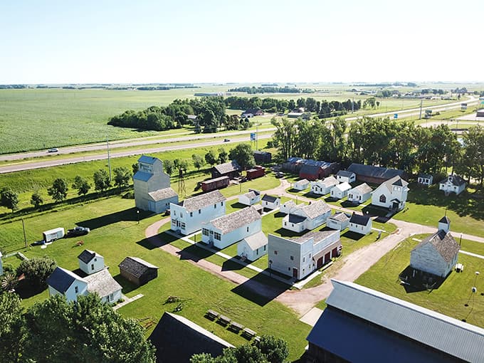 From this aerial view, the village looks like someone carefully arranged a perfect miniature town, except everything's full-sized and historically accurate.