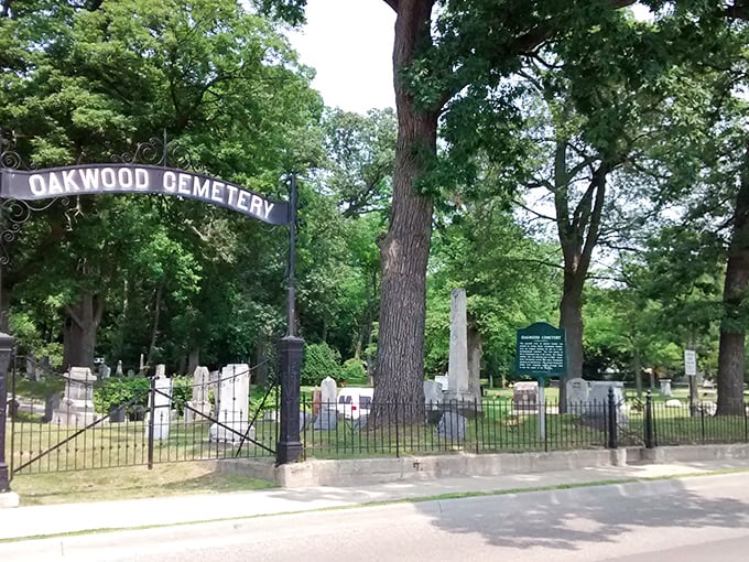 The iconic entrance to Oakwood Cemetery welcomes visitors with historic charm and a hint of mystery lurking beyond the iron gates.