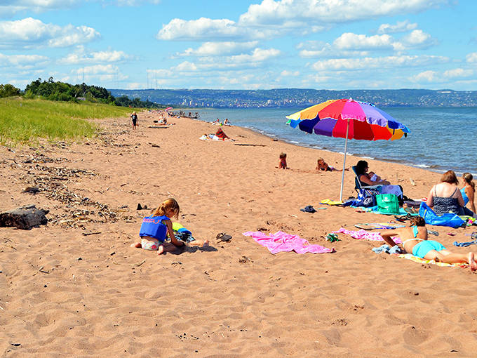 Golden sands stretch for miles along Park Point Beach, where Lake Superior plays its best ocean impersonation under Minnesota's big sky.