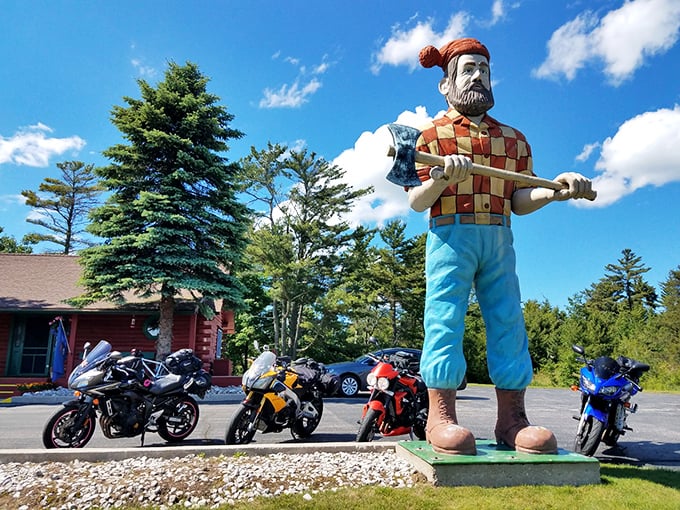 A legendary lumberjack stands tall against Michigan's blue skies, greeting visitors with his trusty axe and unmistakable checkered shirt.