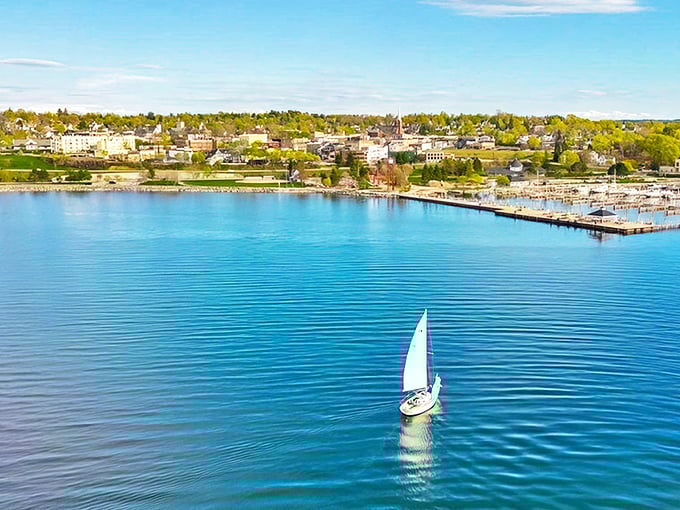 Petoskey's waterfront panorama unfolds like a painter's dream, where sailboats drift across Little Traverse Bay's impossibly blue waters.