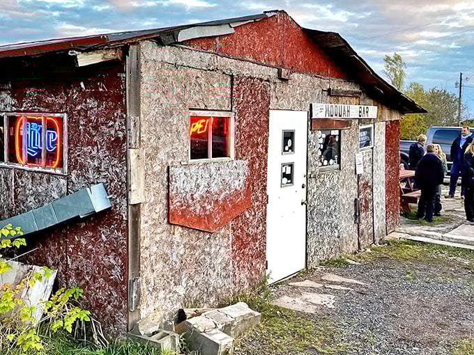 The weathered exterior of Moquah Bar stands defiant against time, a roadside beacon for thirsty travelers seeking authenticity.