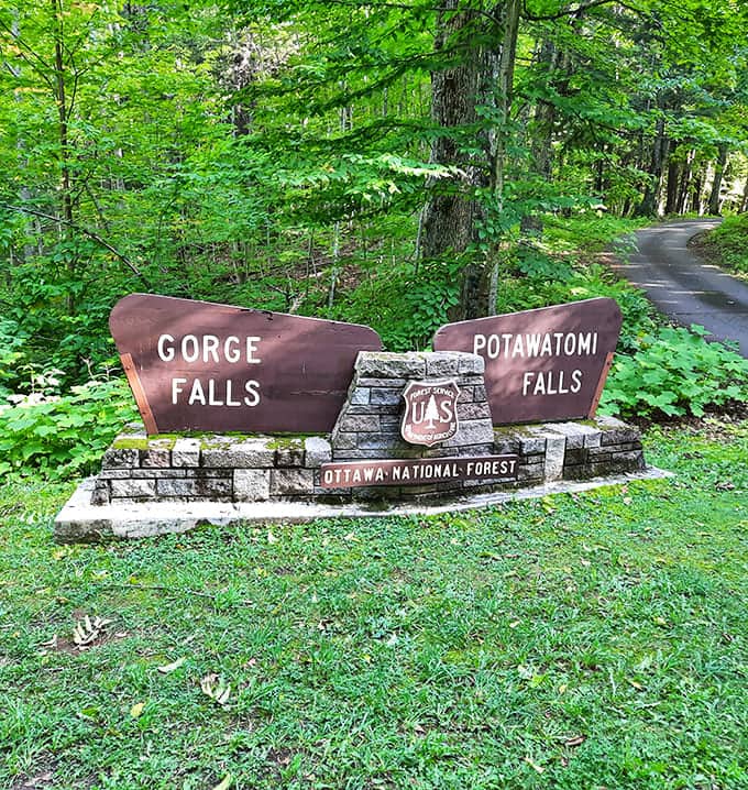 Welcome to nature's double feature! The rustic entrance sign to Gorge and Potawatomi Falls stands like a humble gatekeeper to watery wonders beyond.