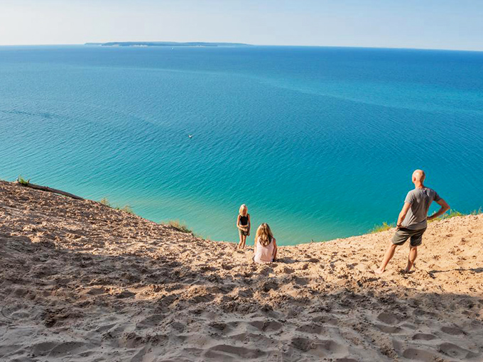 Lake Michigan's turquoise waters create an optical illusion where sky meets water at Pyramid Point's dramatic overlook.