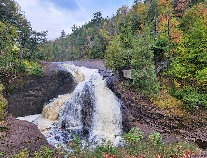 Nature's masterpiece in motion: Rainbow Falls cascades dramatically through Michigan's Ottawa National Forest, creating a spectacle worth every step of the journey.