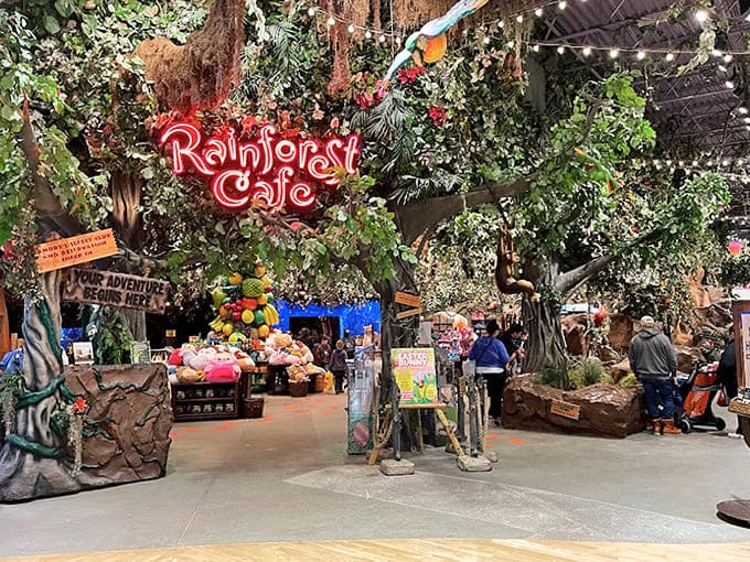 That glowing red sign beckons you into a world where dinner comes with a side of simulated tropical weather and mechanical wildlife.