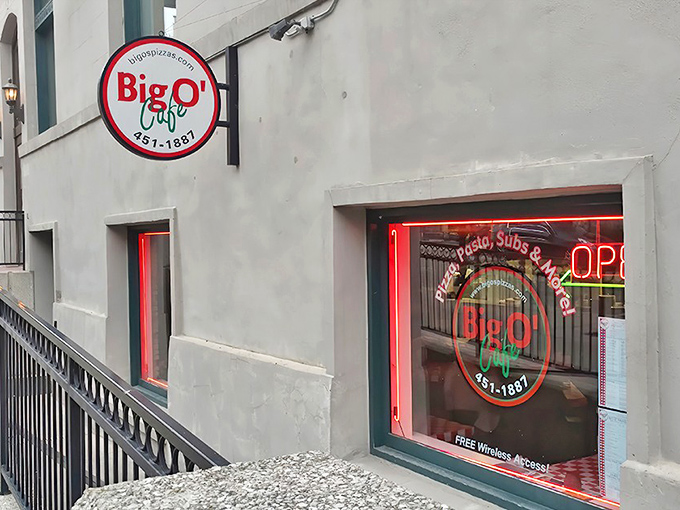 The unassuming exterior of Big O' Cafe beckons pizza lovers with its simple circular sign &ndash; a secret entrance to flavor paradise below street level.