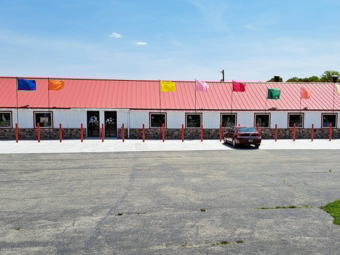 Sea Shell City's distinctive red-roofed exterior stands out against the Michigan sky, colorful flags beckoning travelers to explore the nautical wonderland within.
