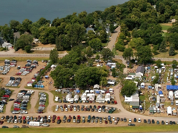Aerial view of Shady Hollow Flea Market reveals the massive scale of this treasure hunter's paradise, with hundreds of cars filling the sprawling parking area.