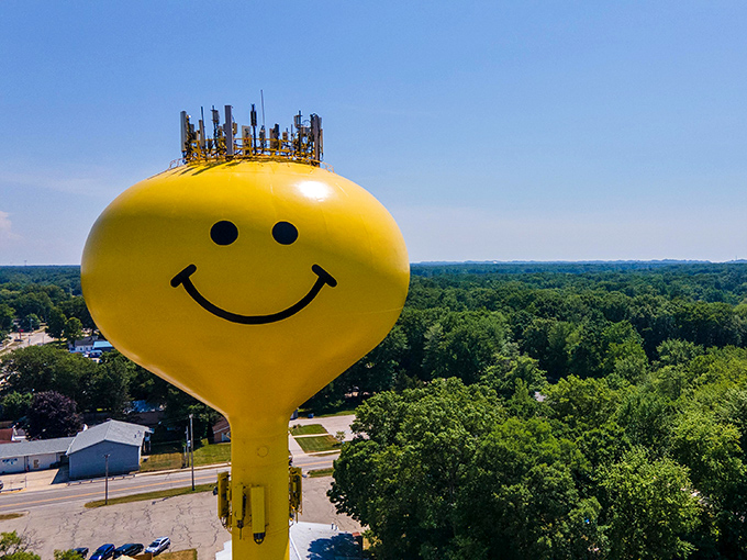 The Fruitport Smiley Face Water Tower stands tall against Michigan's blue sky, a 147-foot beacon of joy that refuses to take itself too seriously.
