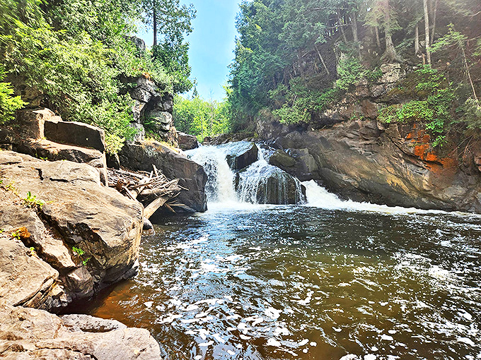 Nature's perfect postcard: Sturgeon Falls tumbles dramatically between ancient rock walls, creating a misty paradise for waterfall chasers.