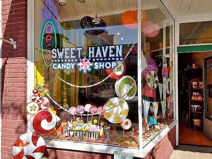 The Sweet Haven storefront beckons like a portal to childhood, its neon "Open" sign practically whispering, "Diet? What diet?"