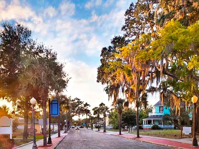 Sunset bathes Tarpon Springs' historic brick streets in golden light, where Spanish moss drapes from oaks like nature's own decorations.