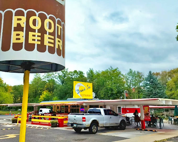 The iconic "ROOT BEER" sign stands tall against Minnesota skies, a beacon of nostalgia that's been drawing hungry travelers to Taylors Falls since the Eisenhower administration.