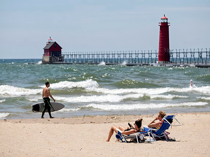 Grand Haven's iconic red lighthouse stands sentinel against Lake Michigan's vast blue horizon, creating Michigan's most postcard-perfect coastal scene.