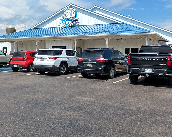 MOO-ville's charming exterior welcomes visitors with its distinctive blue roof and friendly cow logo &ndash; dairy paradise awaits behind those doors!