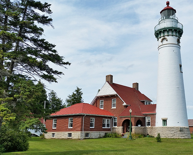 The iconic Seul Choix Lighthouse stands proudly against Michigan's sky, its white tower and red-roofed keeper's house telling stories of maritime history.