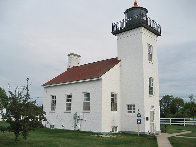 Sand Point Lighthouse stands tall against Michigan's moody skies, its white walls practically daring Lake Michigan to throw another storm its way.