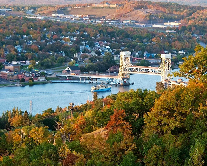 Houghton's autumn splendor unfolds like nature's own fireworks display, with the iconic lift bridge standing proud against a canvas of fiery foliage.
