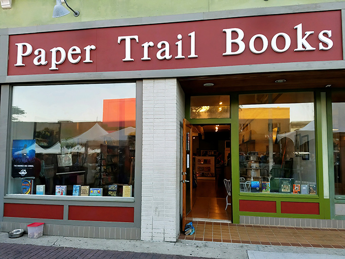 The iconic red sign beckons bibliophiles like a literary lighthouse, promising adventures bound between covers rather than oceans.