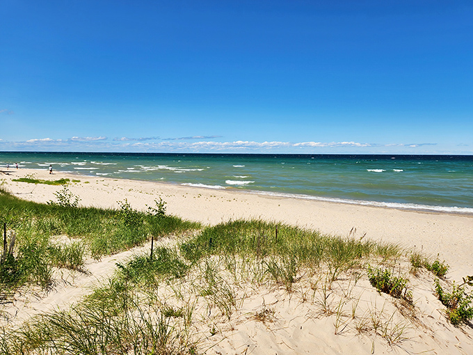 Agate Beach stretches out like nature's welcome mat, where Lake Huron's turquoise waters meet pristine sand in Rogers City's best-kept secret.