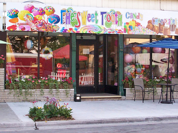 The Sweet Tooth's vibrant storefront beckons with a rainbow of colors, promising a sugar-fueled adventure that would make Willy Wonka jealous.