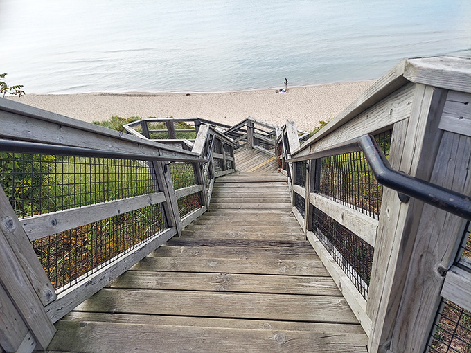 Wooden stairs cascade down to Lake Michigan's shoreline, promising adventure with every step at Tunnel Park.