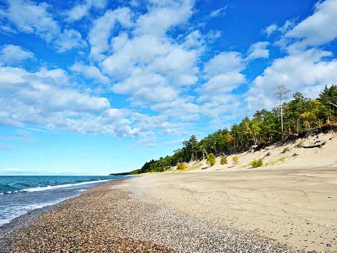 Twelvemile Beach stretches like nature's welcome mat, where Lake Superior meets pristine sand under an impossibly blue Michigan sky.