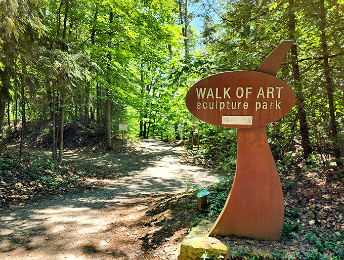 The entrance to Walk of Art beckons visitors with its rustic charm &ndash; nature's gallery awaits beyond this sculptural signpost.
