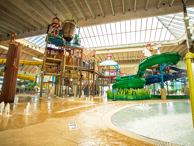 The grand indoor oasis of Breaker Bay Waterpark stretches beneath skylights, where twisting slides and splashing fountains promise year-round summer adventures.