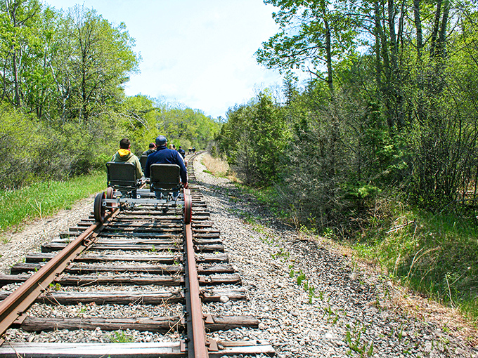 Pedal-powered adventure awaits as riders glide through Michigan's lush greenery on specialized rail bikes, creating memories with every click of the tracks.