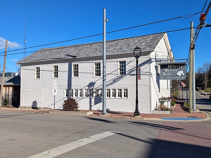 The historic White Horse Inn stands proudly in Metamora, its classic clapboard exterior virtually unchanged since stagecoach days, welcoming modern travelers to step back in time.