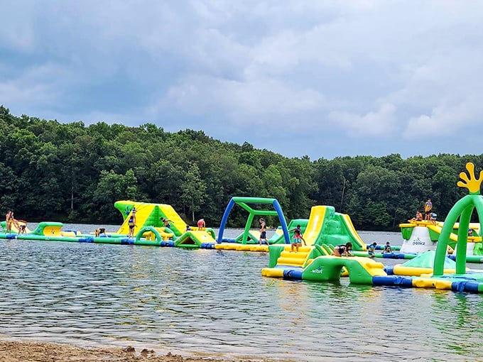 A floating playground paradise stretches across Heron Beach, where neon inflatables transform an ordinary lake into an extraordinary adventure zone.