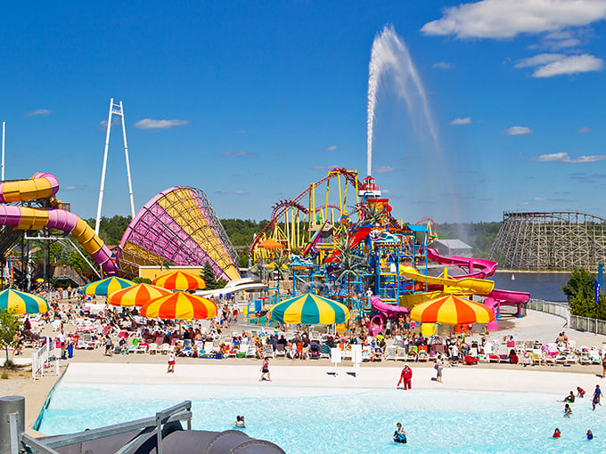 Wildwater Adventure's main plaza buzzes with summer energy as colorful umbrellas dot the landscape like confetti thrown by a giant celebrating the perfect day.