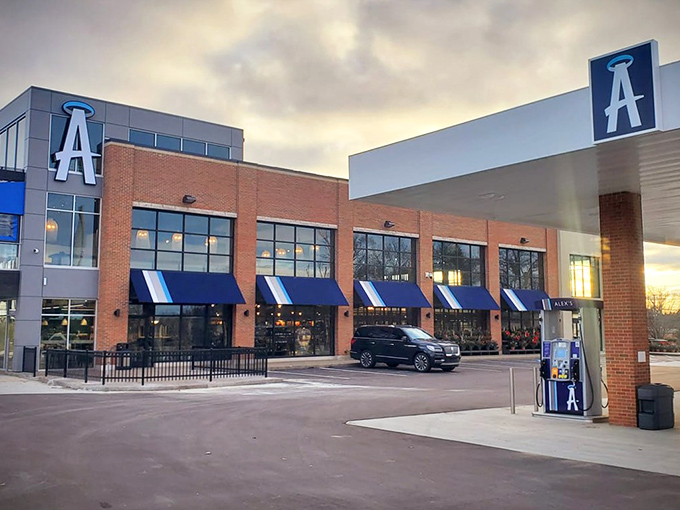 The blue awnings and brick facade of Alex's Gourmet Market create an unexpected culinary oasis where most would just expect to fill their tanks.