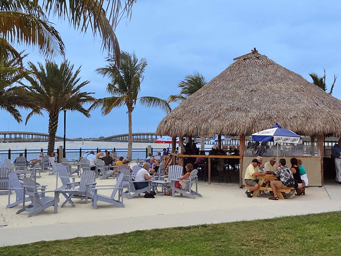 Paradise found! The thatched-roof tiki hut beckons with promises of cold drinks and harbor views that'll make your worries drift away.