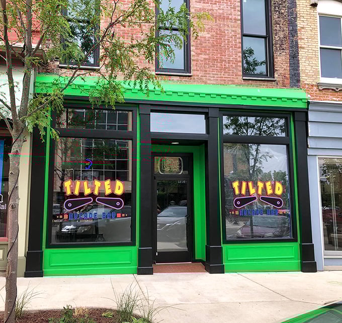 The unmistakable electric green storefront of Tilted Arcade Bar beckons from downtown Jackson like a neon-lit portal to your gaming past.