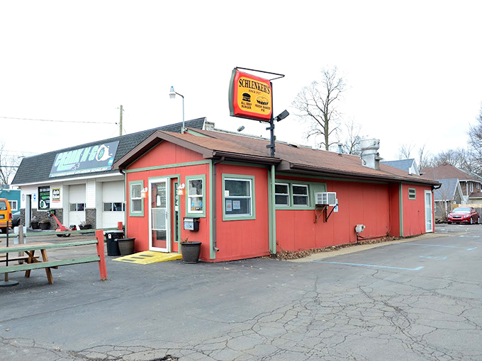 The coral-colored exterior of Schlenker's stands like a time capsule of American burger tradition, beckoning hungry travelers with its vintage charm.